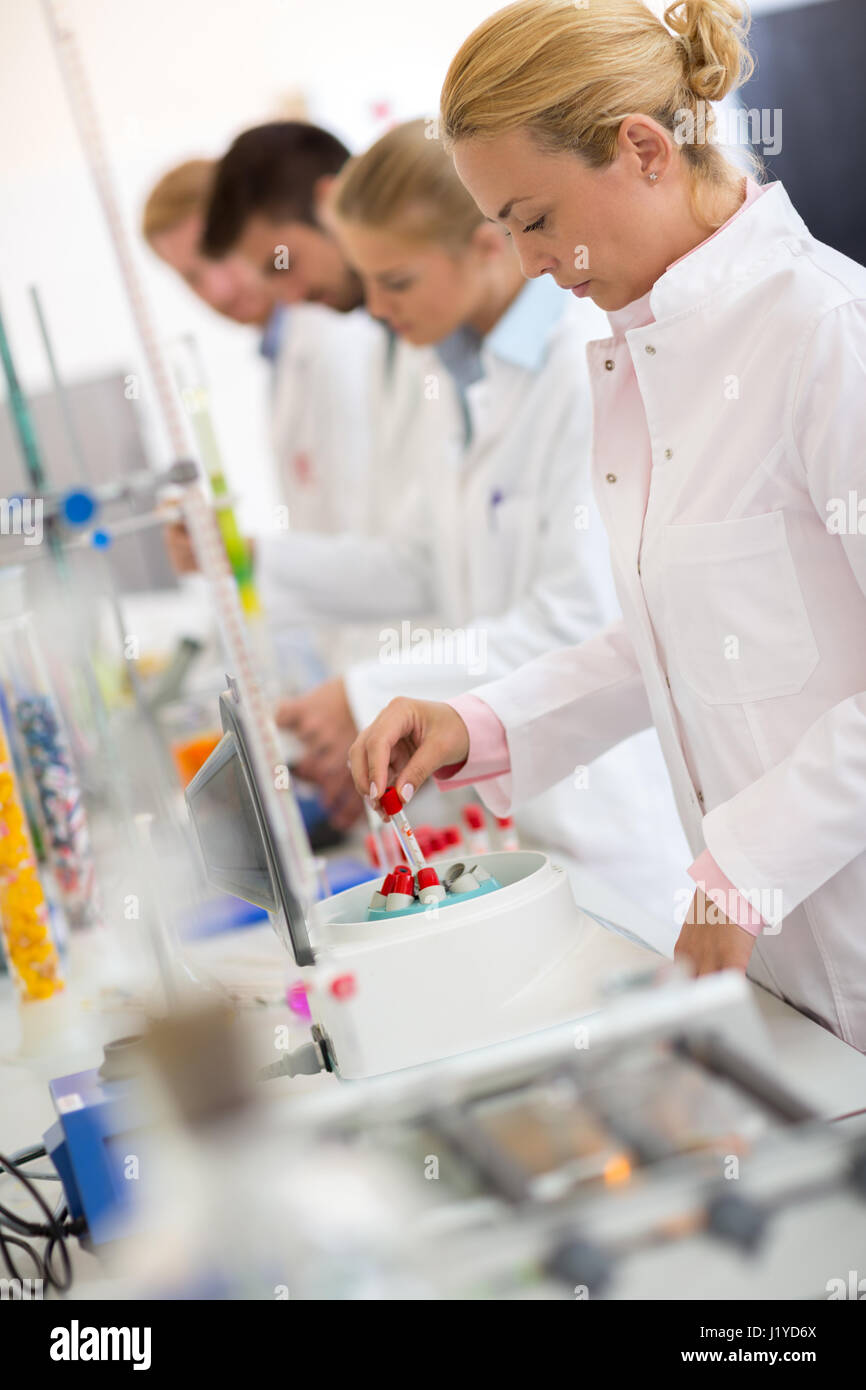 Group of young technicians work with test tubes in laboratory Stock ...
