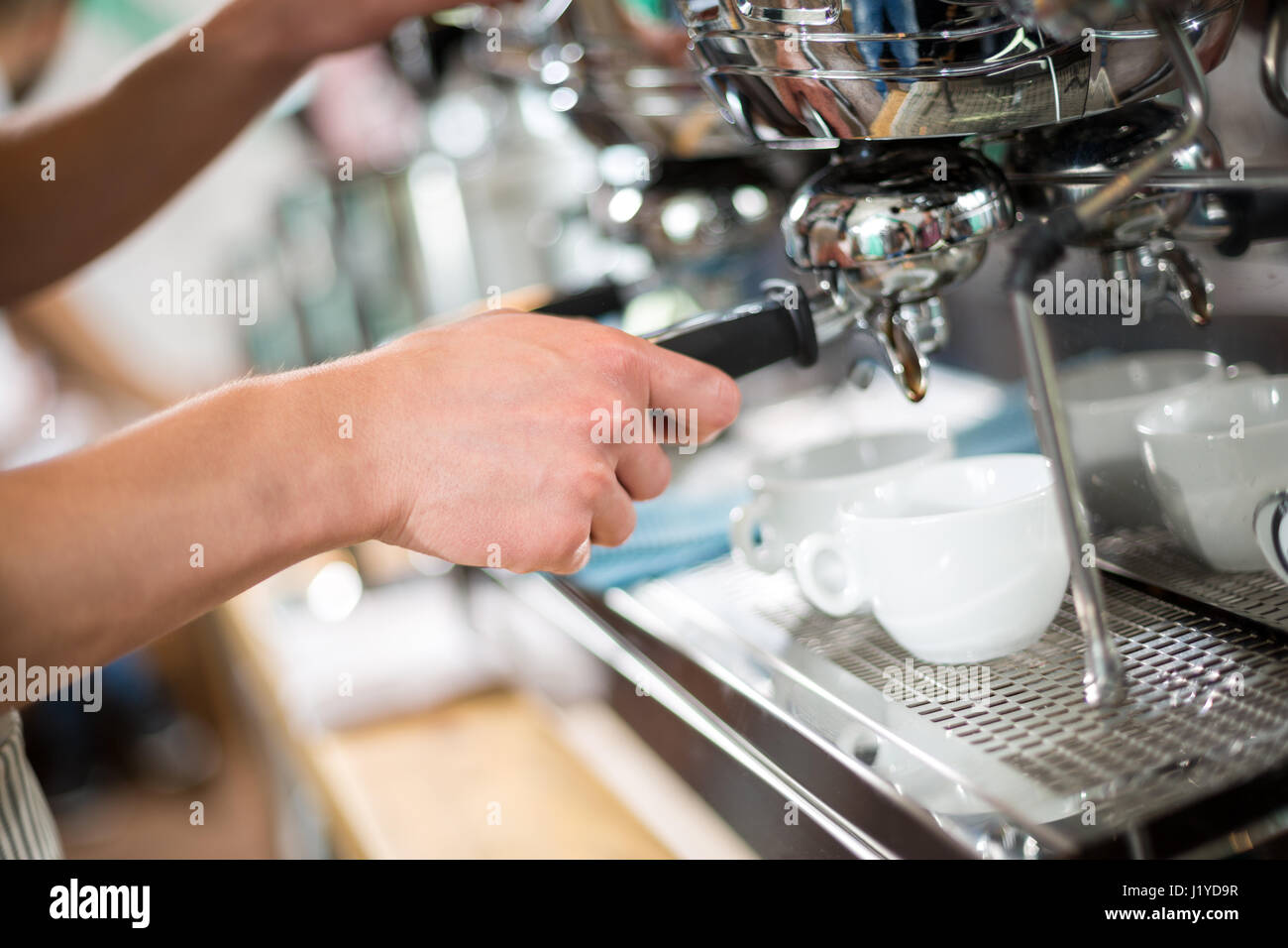 male bartender makes coffee using coffee machine Stock Photo - Alamy