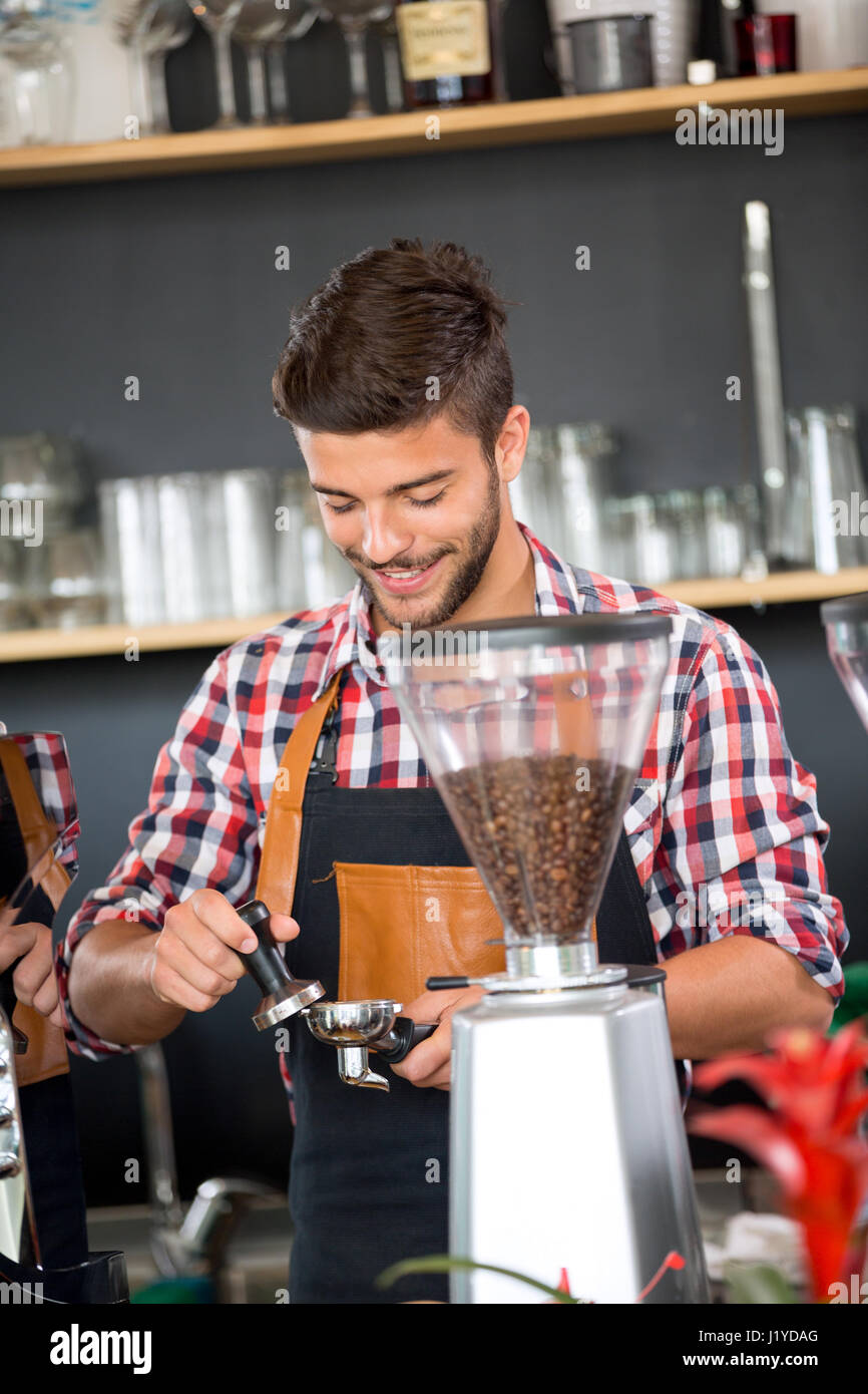Smiling waiter preparing espresso at coffee shop Stock Photo - Alamy
