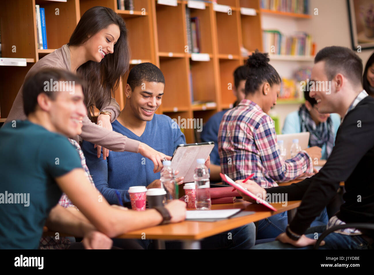 Classmates socializing and studying together after class Stock Photo ...