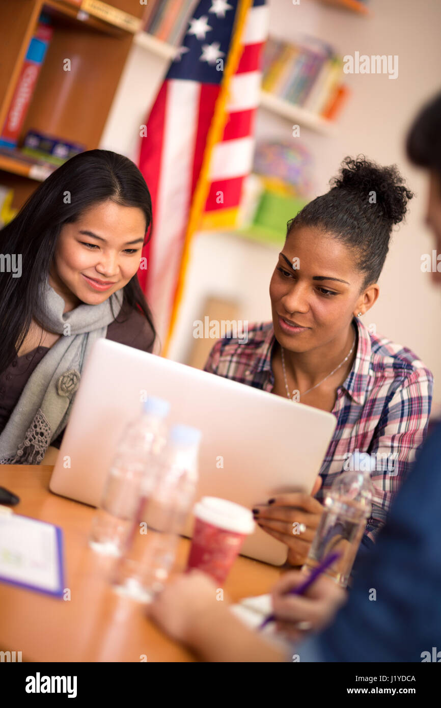 Couple of female classmates studying for exam after lecture in college ...
