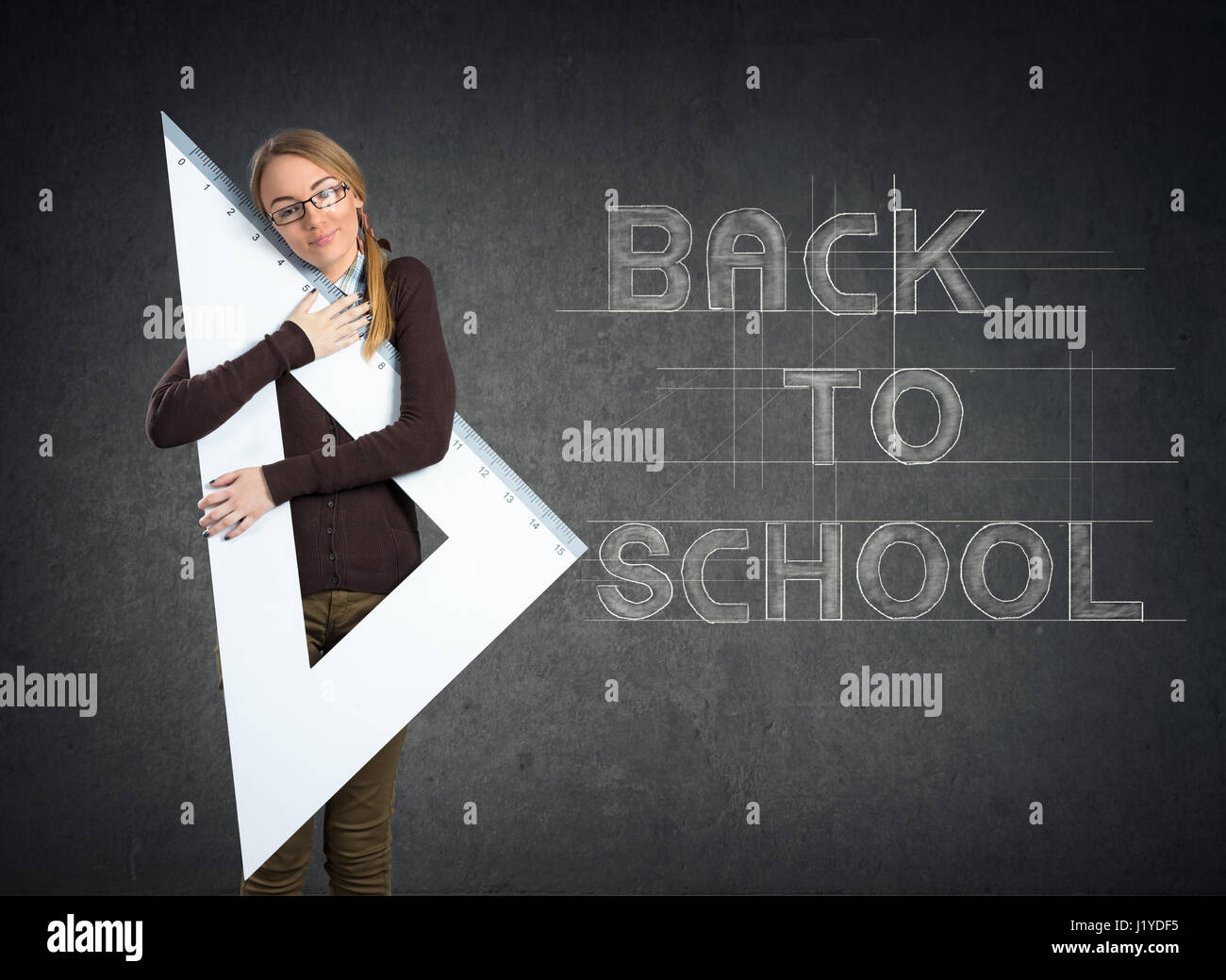 young student girl hugging big ruler Stock Photo - Alamy