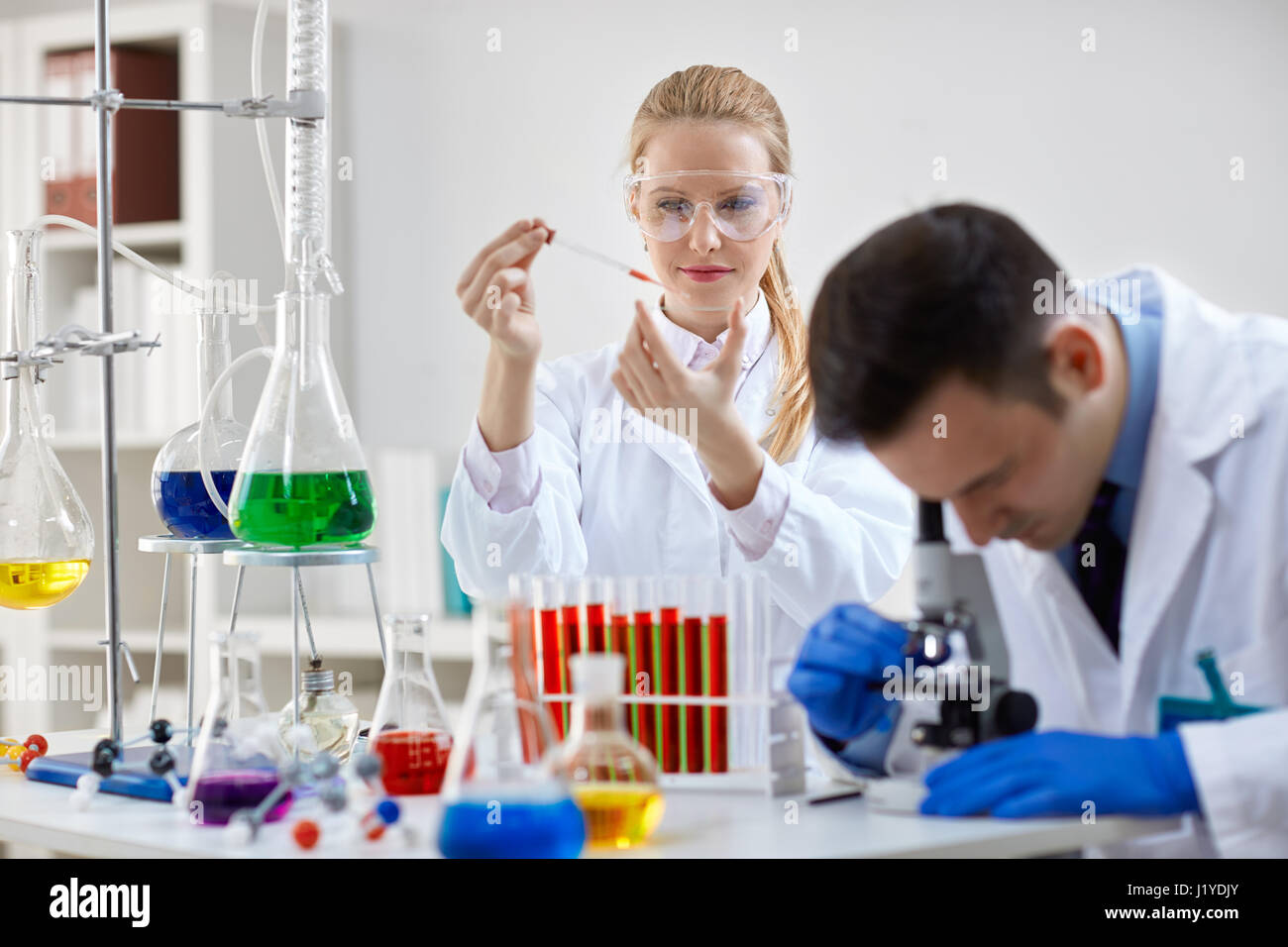 Two young science technicians at work in the laboratory Stock Photo - Alamy