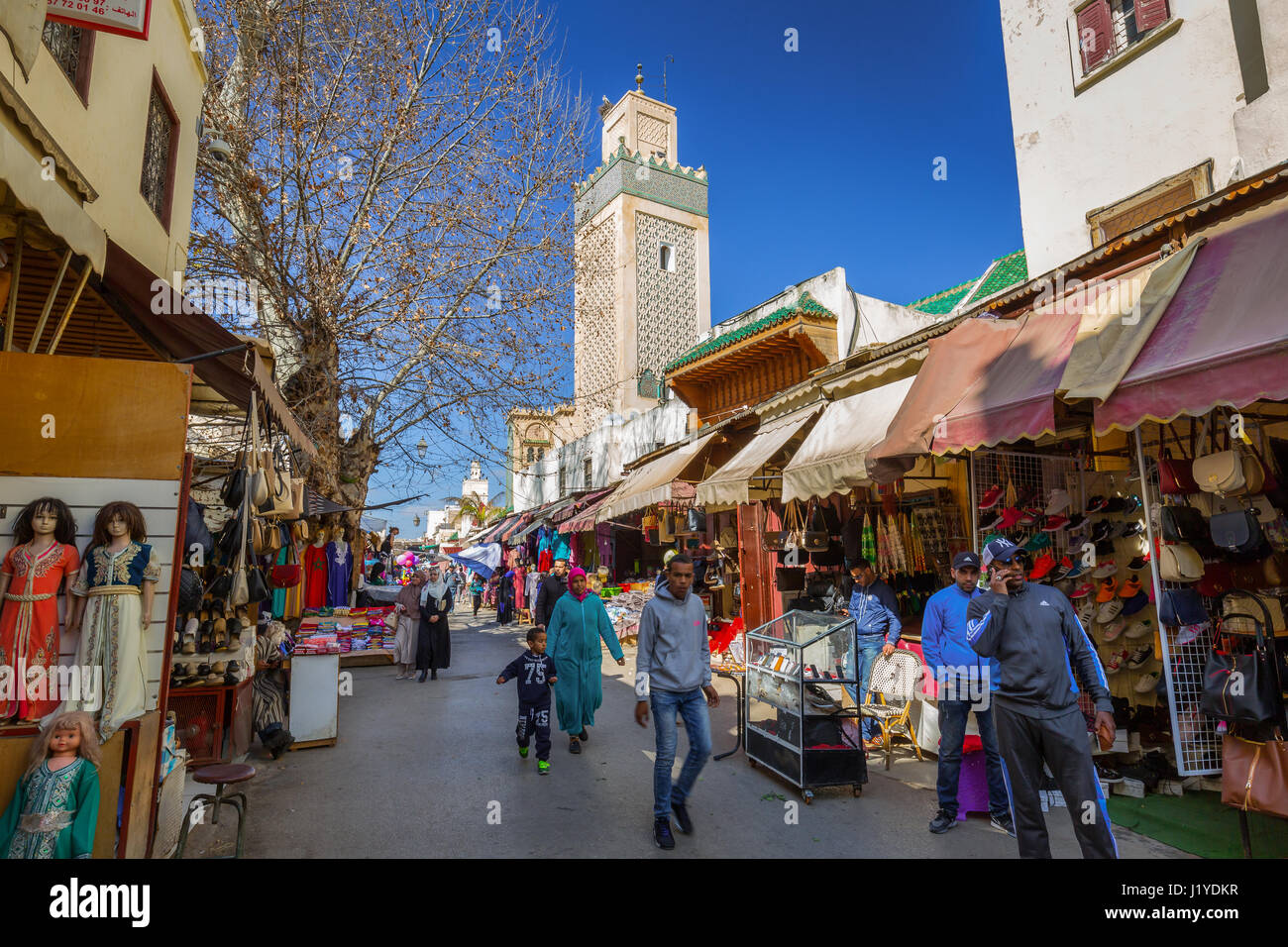 Fes, Morocco - March 01, 2017: Mosque in background of busy street of ...