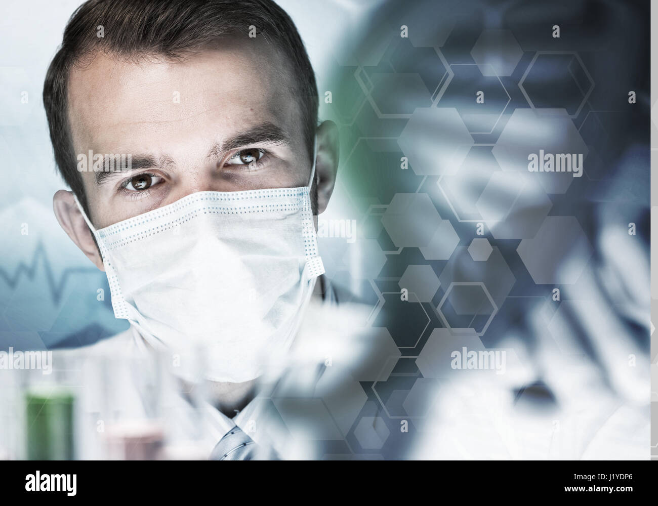 Portrait of concentrated male scientist working with reagents in ...