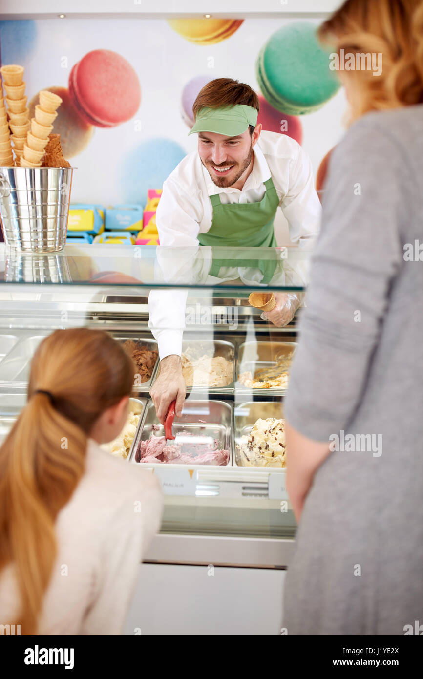 Worker in pastry store serving girl with ice cream Stock Photo - Alamy