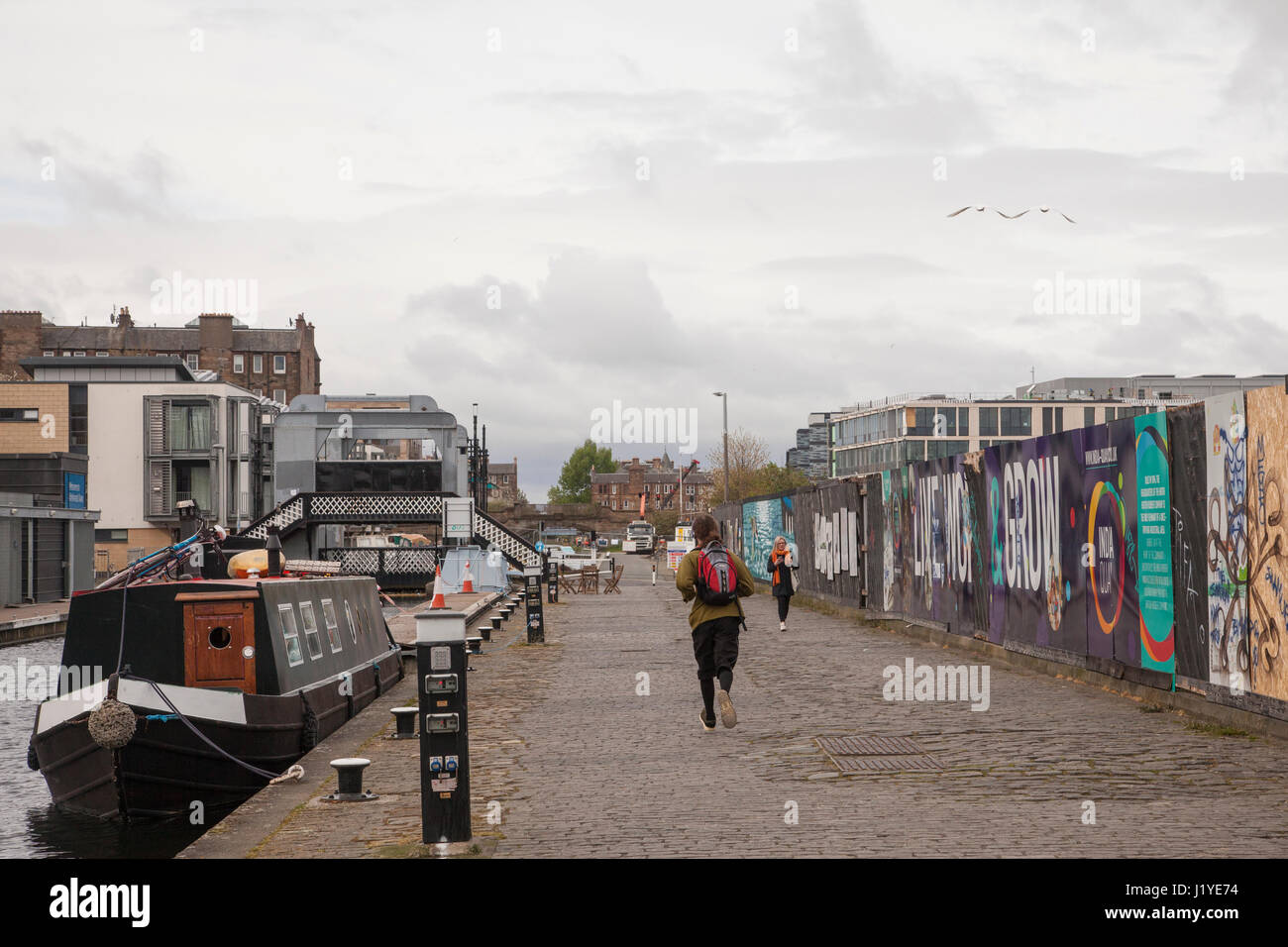 Man running beside Union canal near Toll Cross in Edinburgh, Scotland ...