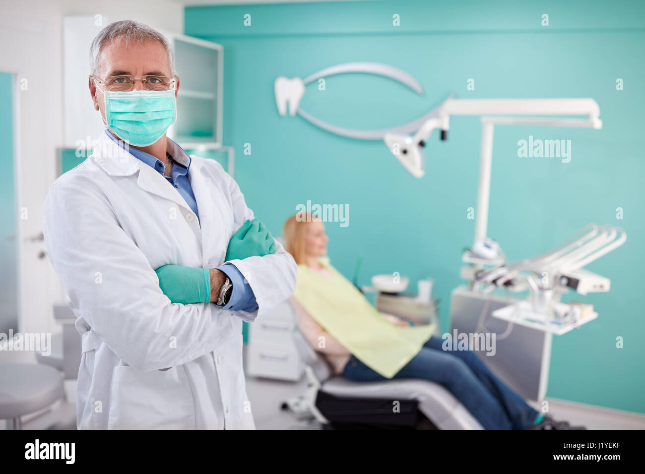 Male dentist with protecting equipment posing in dental clinic Stock ...