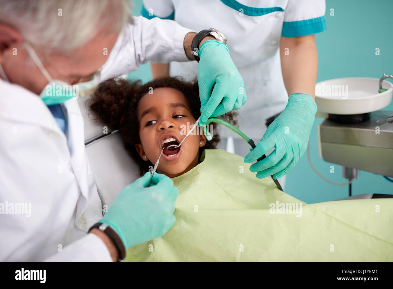 Black kid in chair on dental check up Stock Photo - Alamy