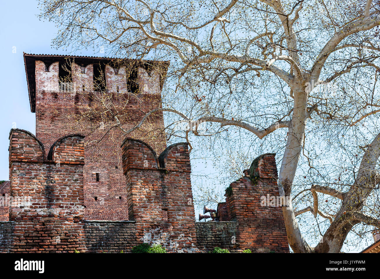 travel to Italy - view of tower and wall with m-shaped merlons of ...