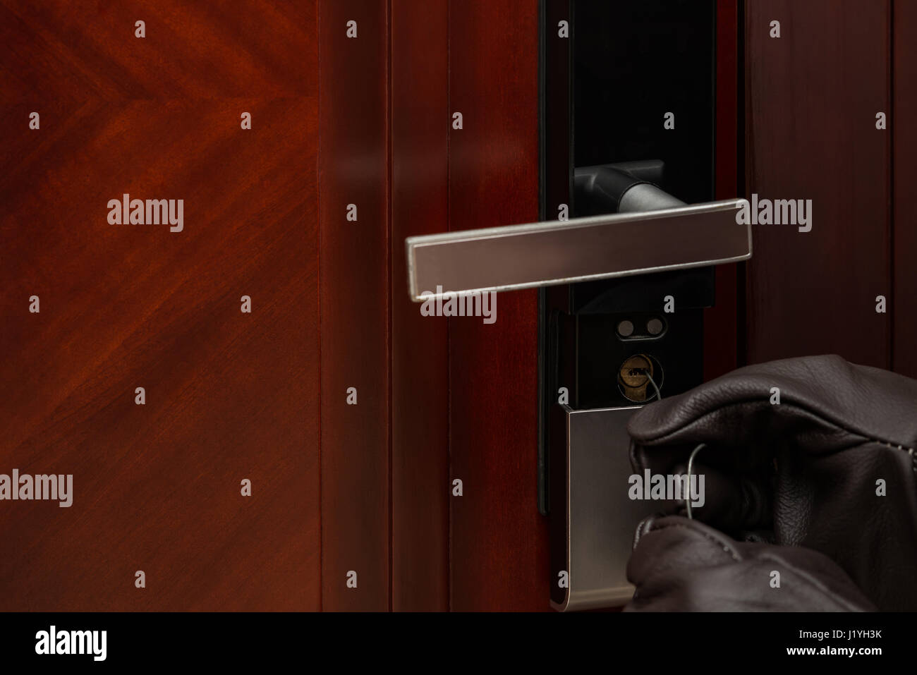 thief opening a door lock by steel wire Stock Photo - Alamy