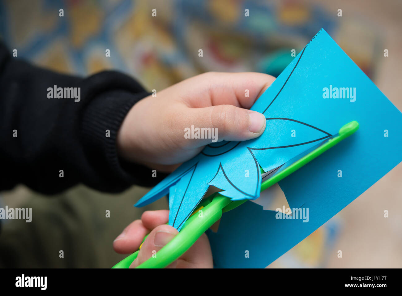 kid doing paper cutting at home Stock Photo - Alamy