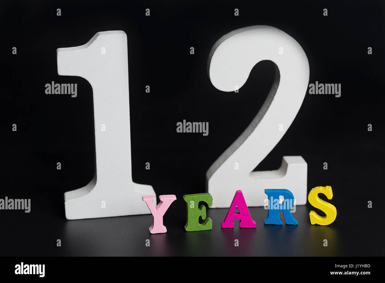 Letters and numbers for twelve years on a black isolated background ...