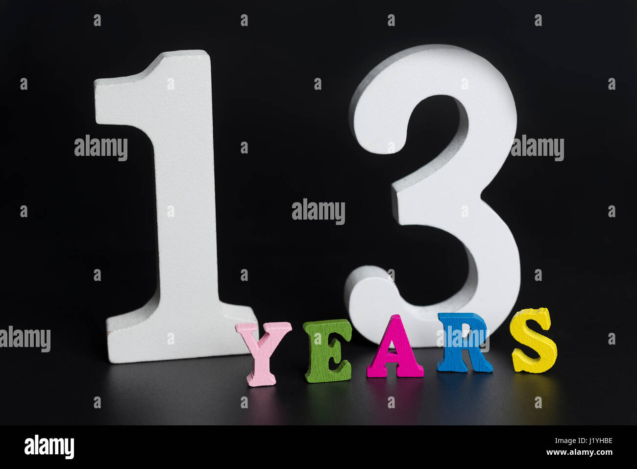 Letters and numbers thirteen on black isolated background Stock Photo ...