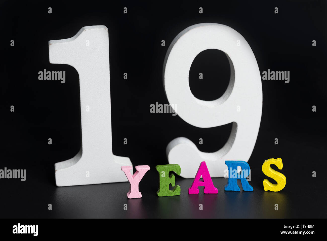 Letters and numbers nineteen years on black isolated background Stock ...