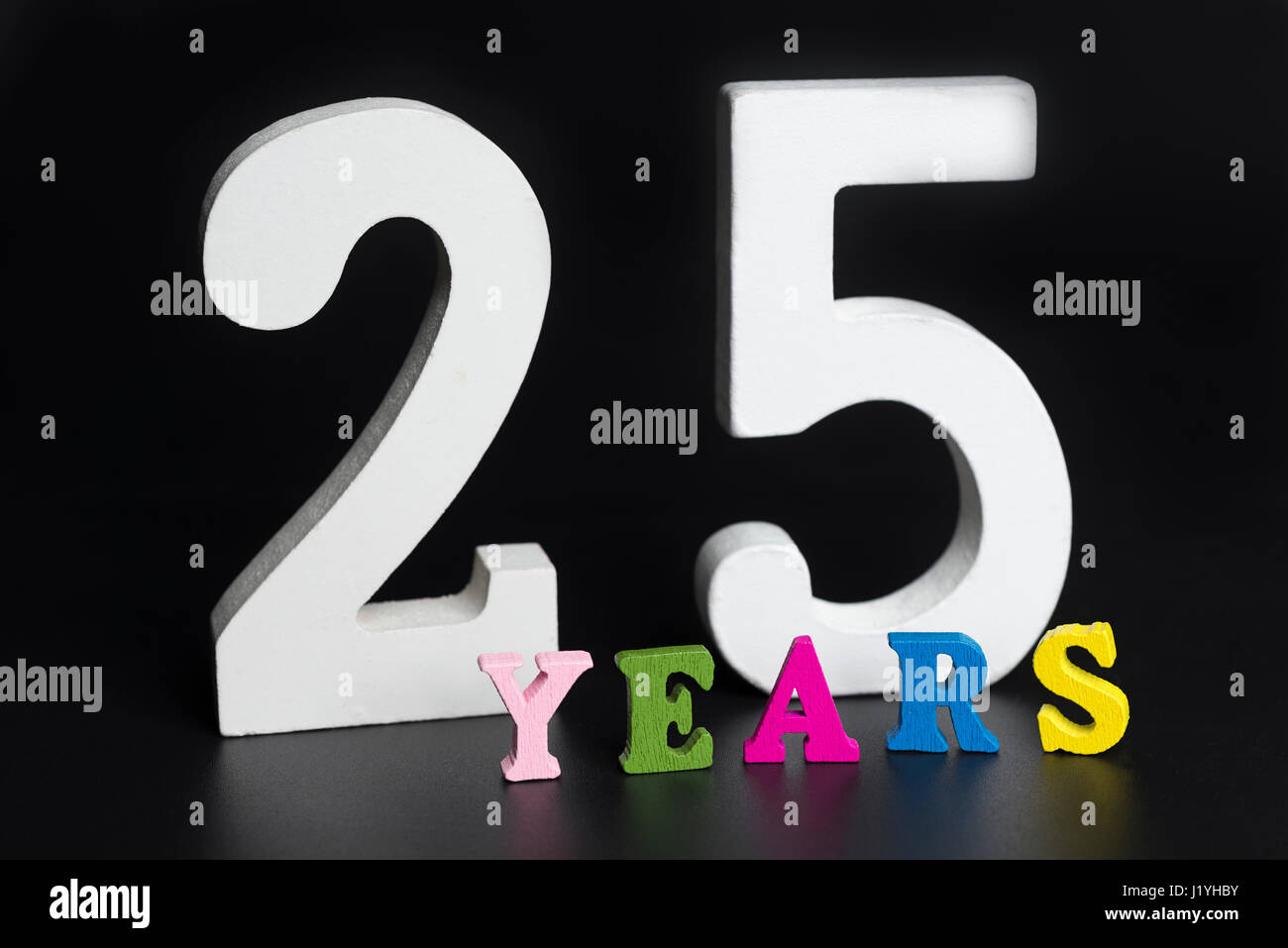 Letters and numbers for twenty-five years on a black isolated ...