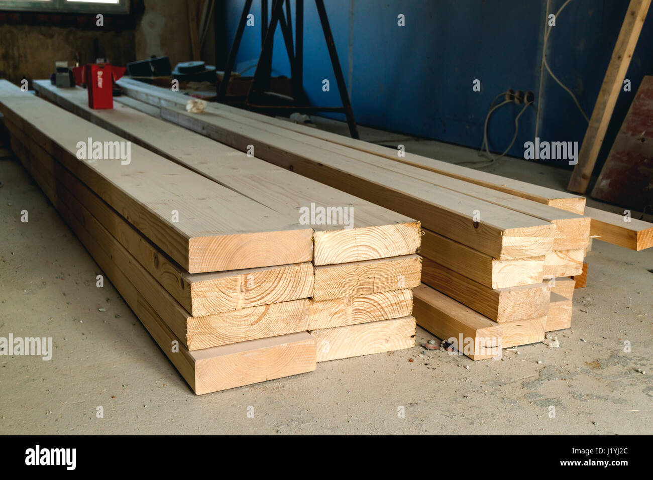 Stack of new wooden studs at the lumber yard. Wood timber construction ...