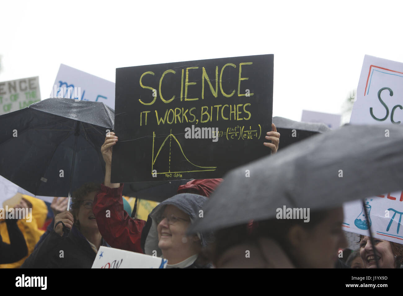 Washington, DC, USA. 22nd Apr, 2017. Protesters hold up signs at the ...