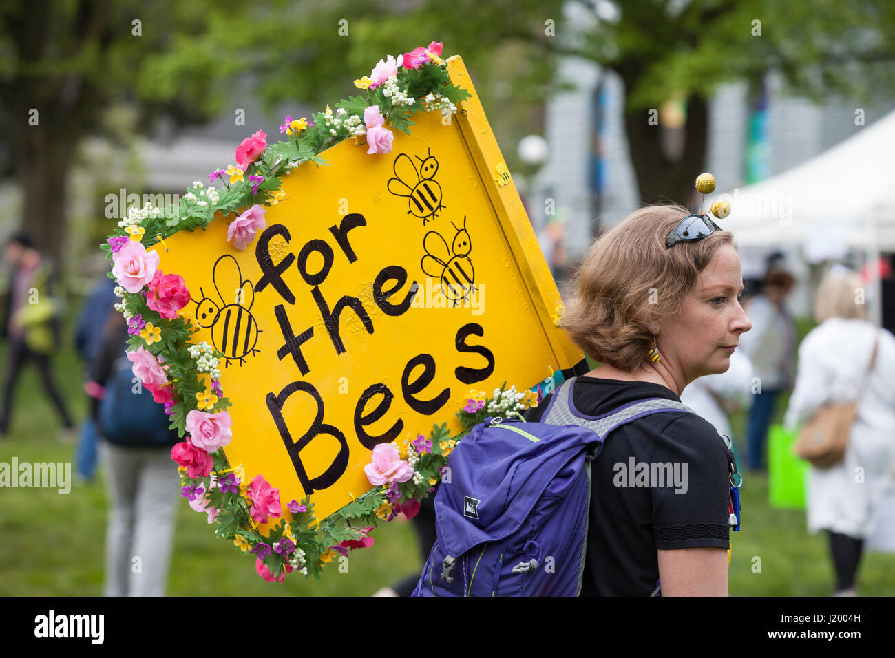 Seattle, Washington,USA. 22nd April, 2017. Woman in a bee costume holds ...