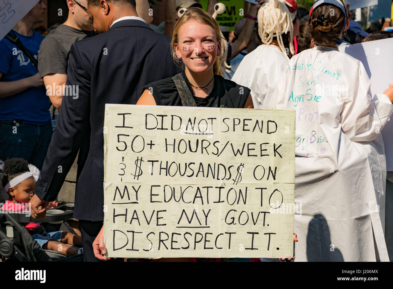 This sign was made with the protester's old homework paper covered in ...
