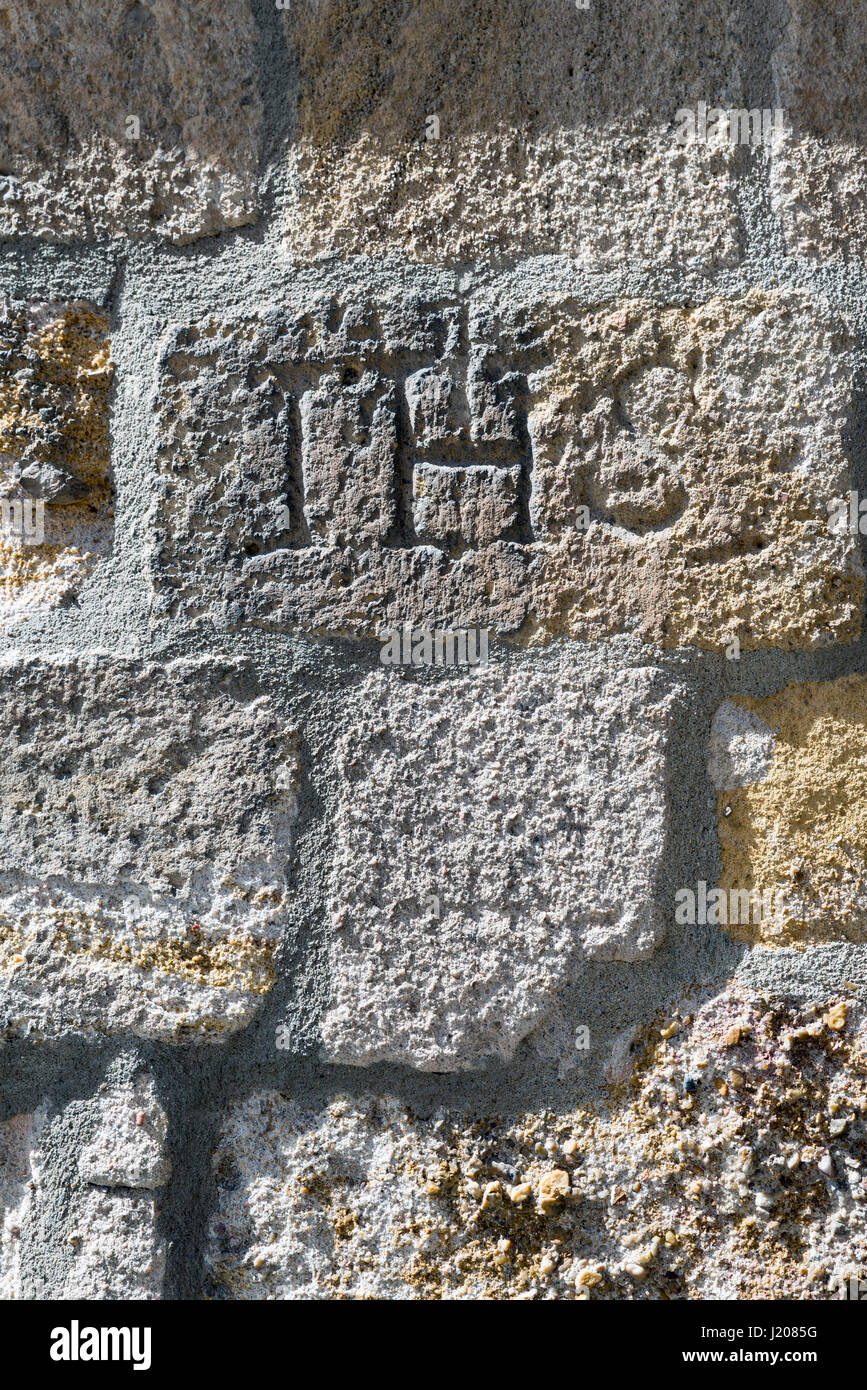 The IHS letters engraved on the front of a house Stock Photo - Alamy