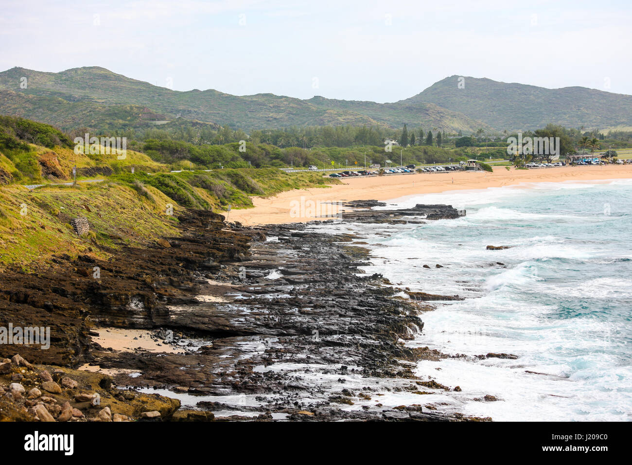 Dangerous rocks lead up to the hazardous Sandy Beach, which is ...