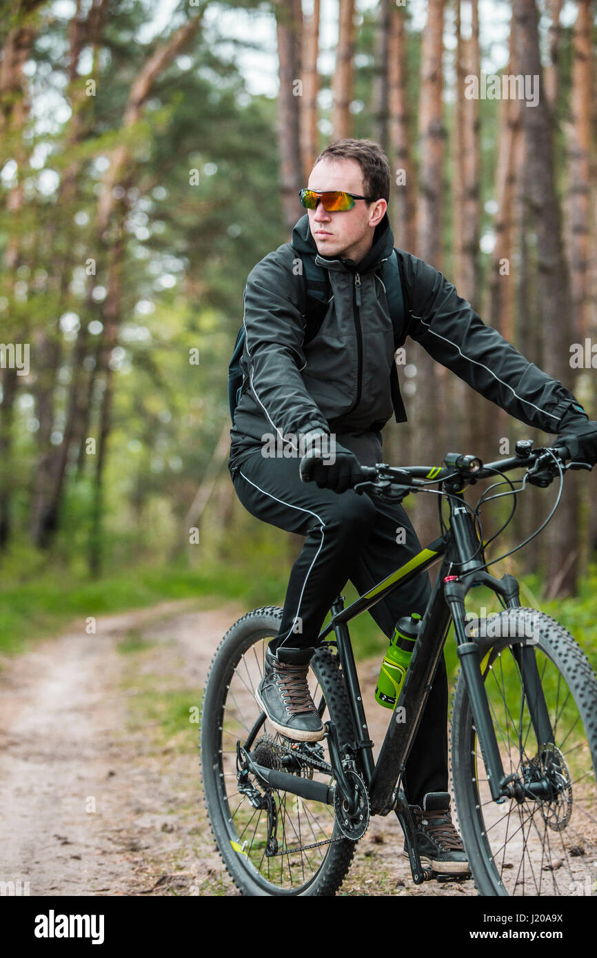 Man Rides a Bike in the Forest Stock Photo - Alamy