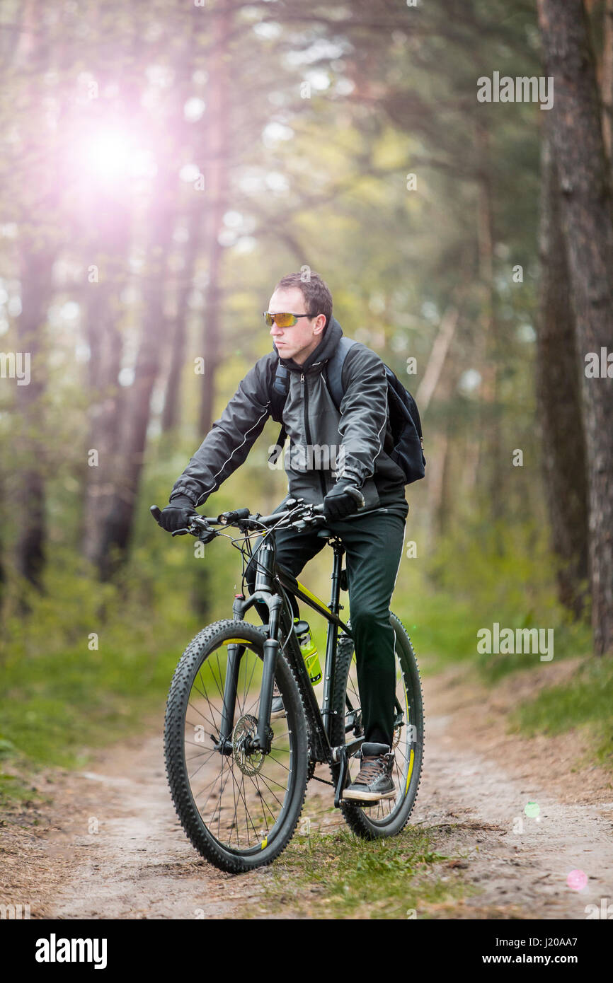 Man Rides a Bike in the Forest Stock Photo - Alamy