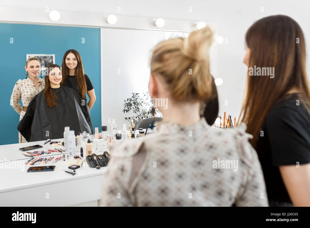 reflection in the mirror satisfied client with ready makeup in beauty ...