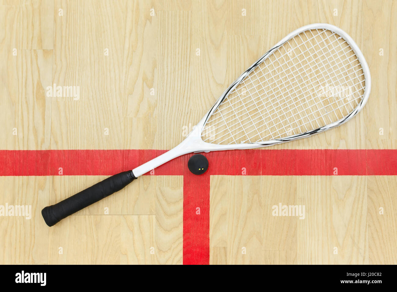 squash racket and ball on the wooden background view from above ...