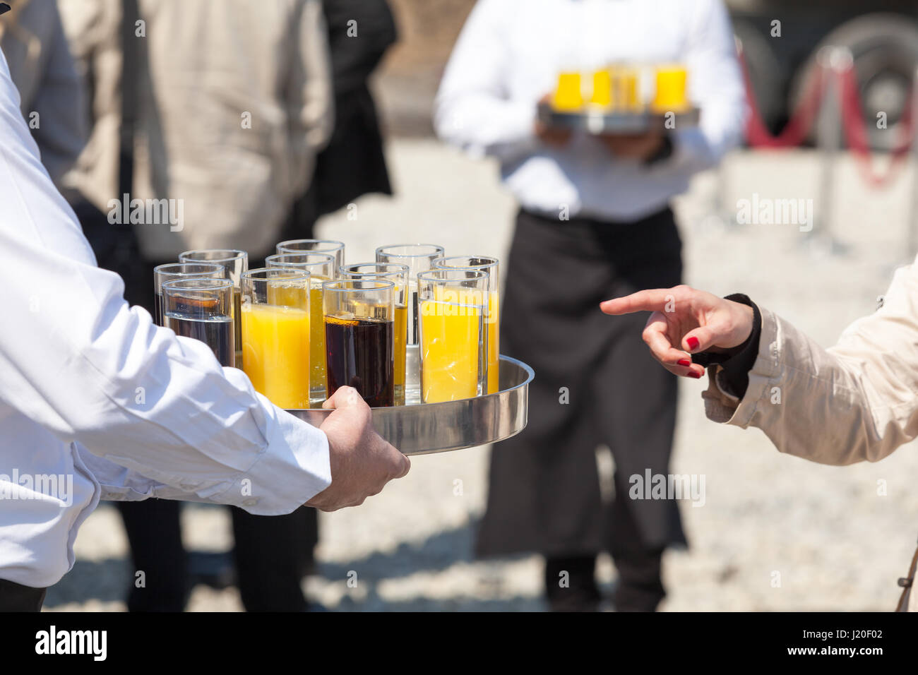 Waiter holding tray water hi-res stock photography and images - Alamy