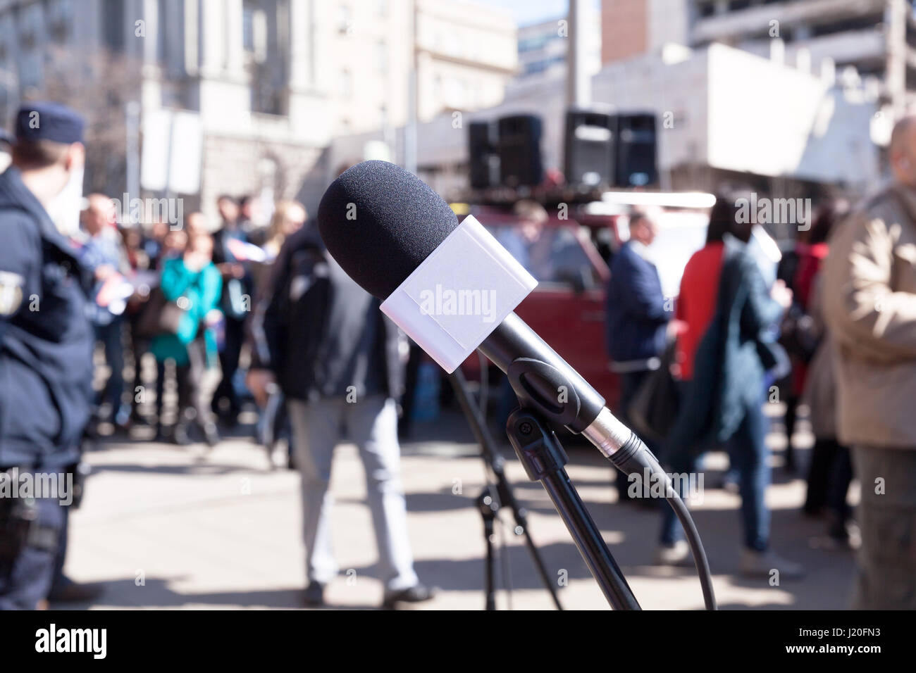Microphone in focus, blurred crowd in background Stock Photo - Alamy