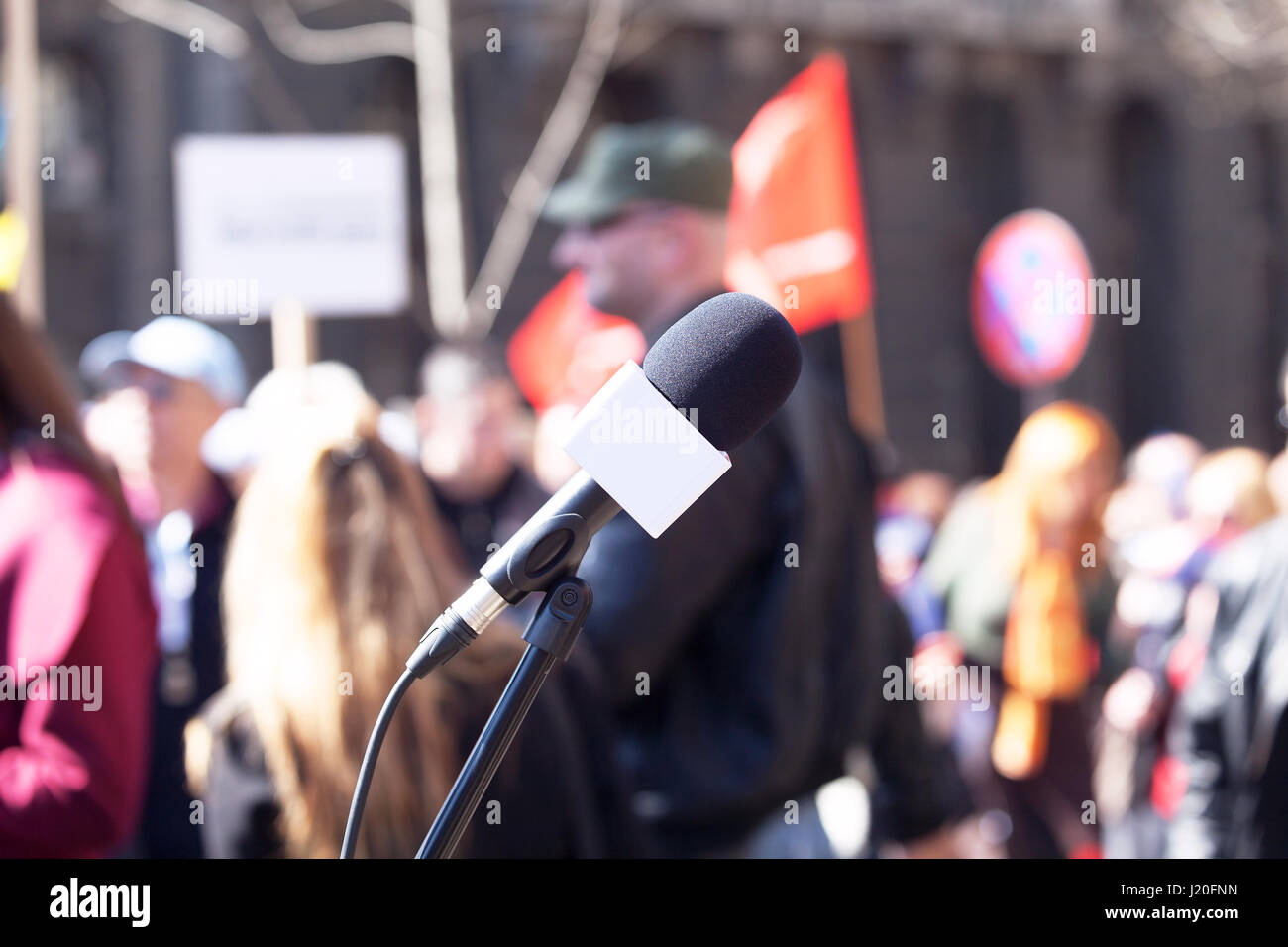 Microphone in focus, blurred crowd in background Stock Photo - Alamy