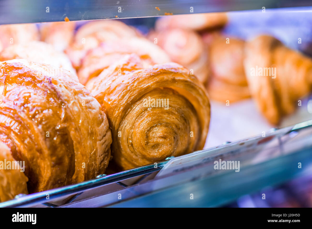 Macro closeup of glazed honey buns on display in bakery Stock Photo - Alamy