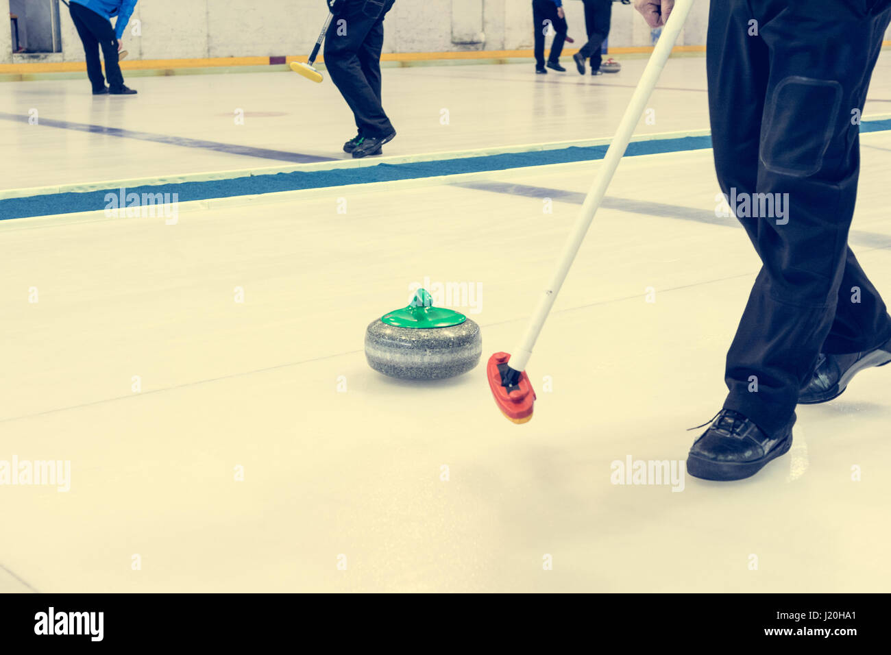 Playing a game of curling. Favorite winter game on ice Stock Photo - Alamy