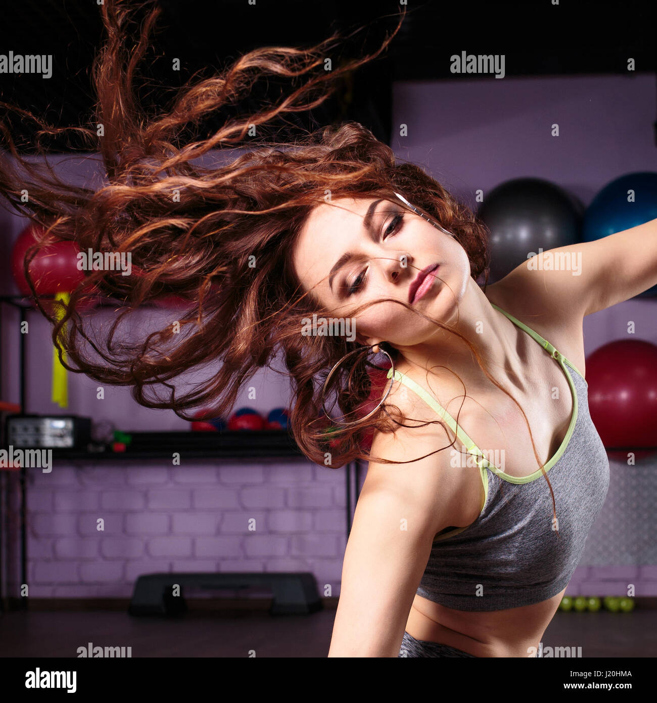 Young dancer woman dancing zumba exercises in health center. Healthy ...
