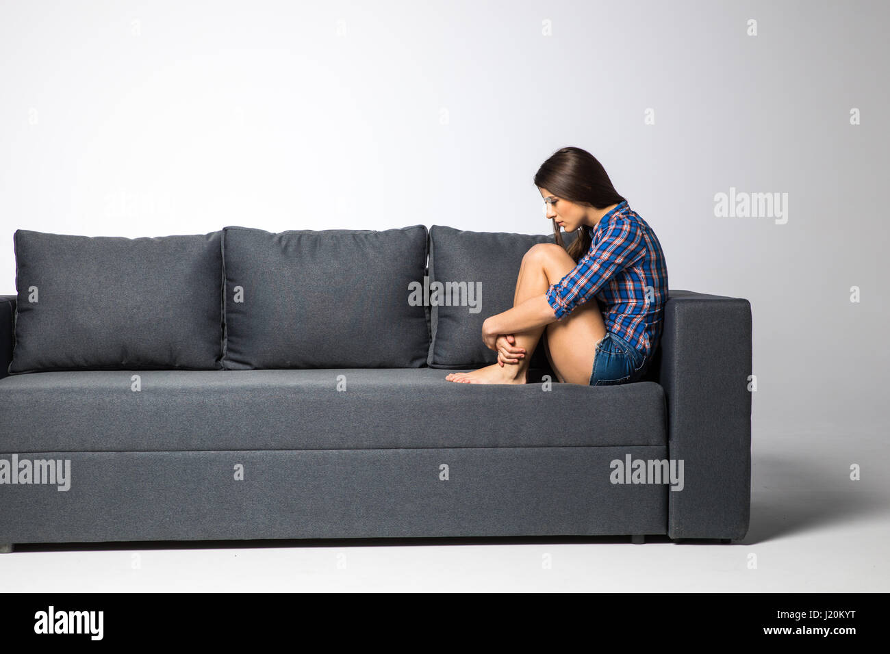 Woman And Sad And Alone And Couch Stock Photos & Woman And Sad And ...
