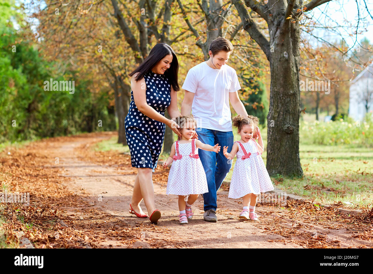 Happy family walks play in the park Stock Photo - Alamy