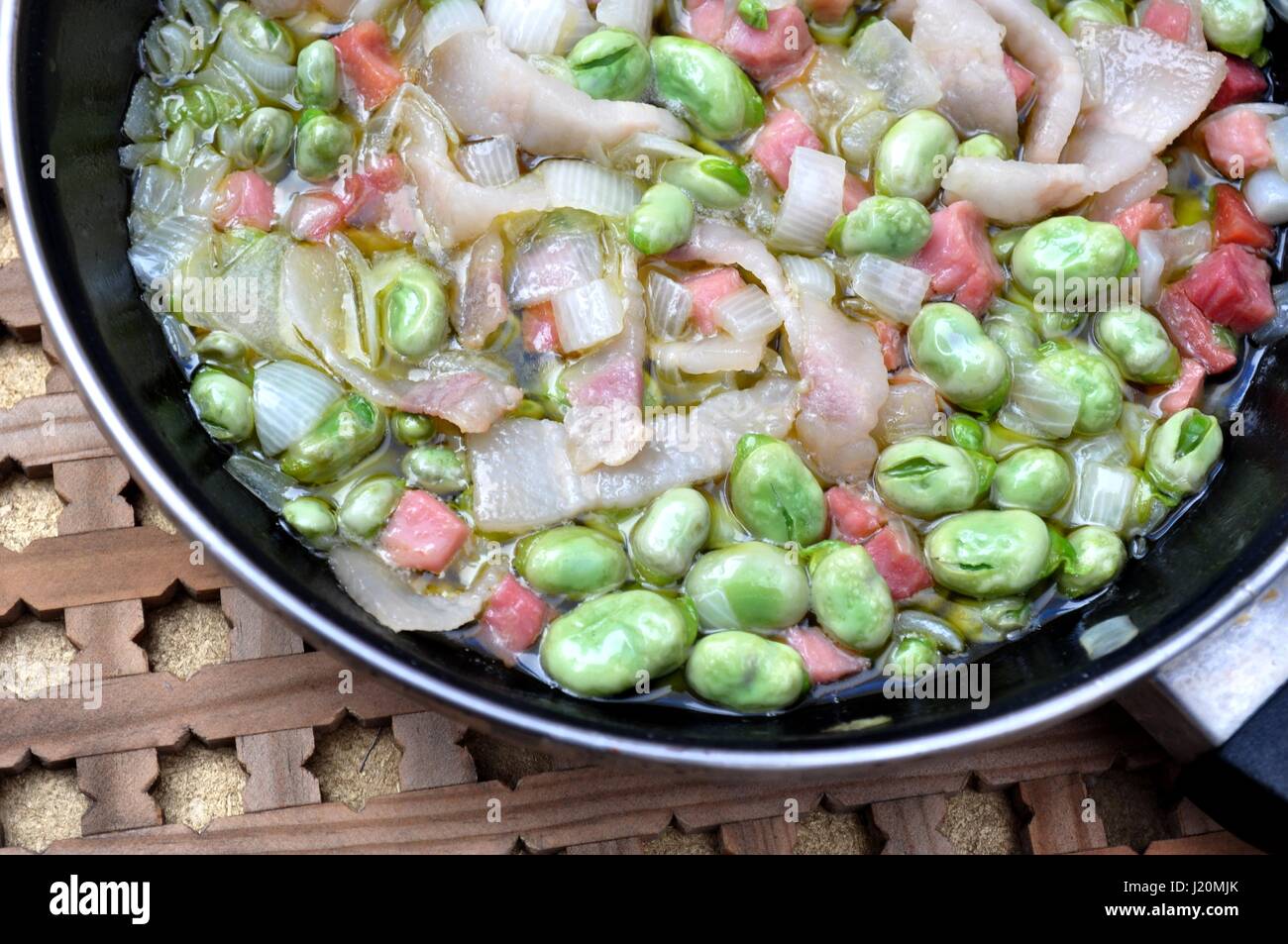 frying pan with broad beans cooking with ham Stock Photo - Alamy
