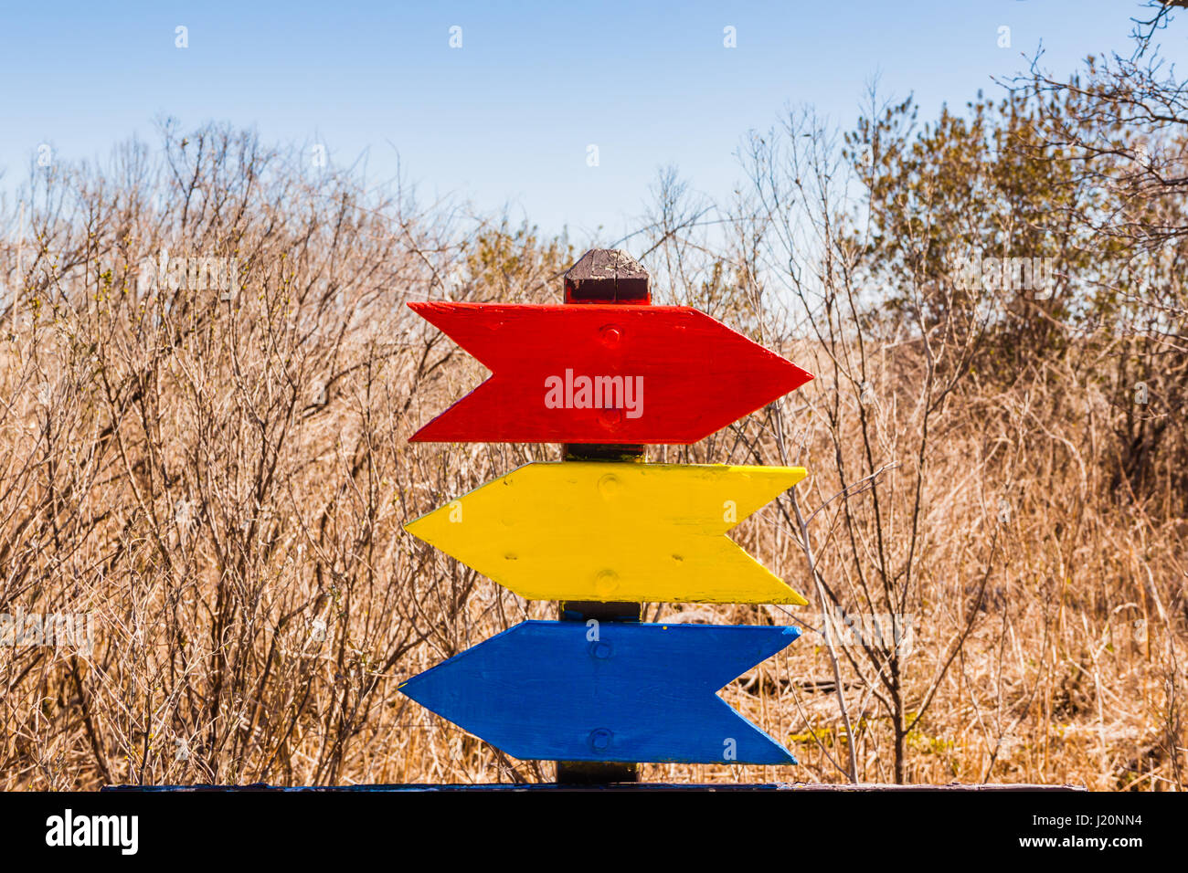 Blank signs shaped like arrow in primary colors Stock Photo - Alamy