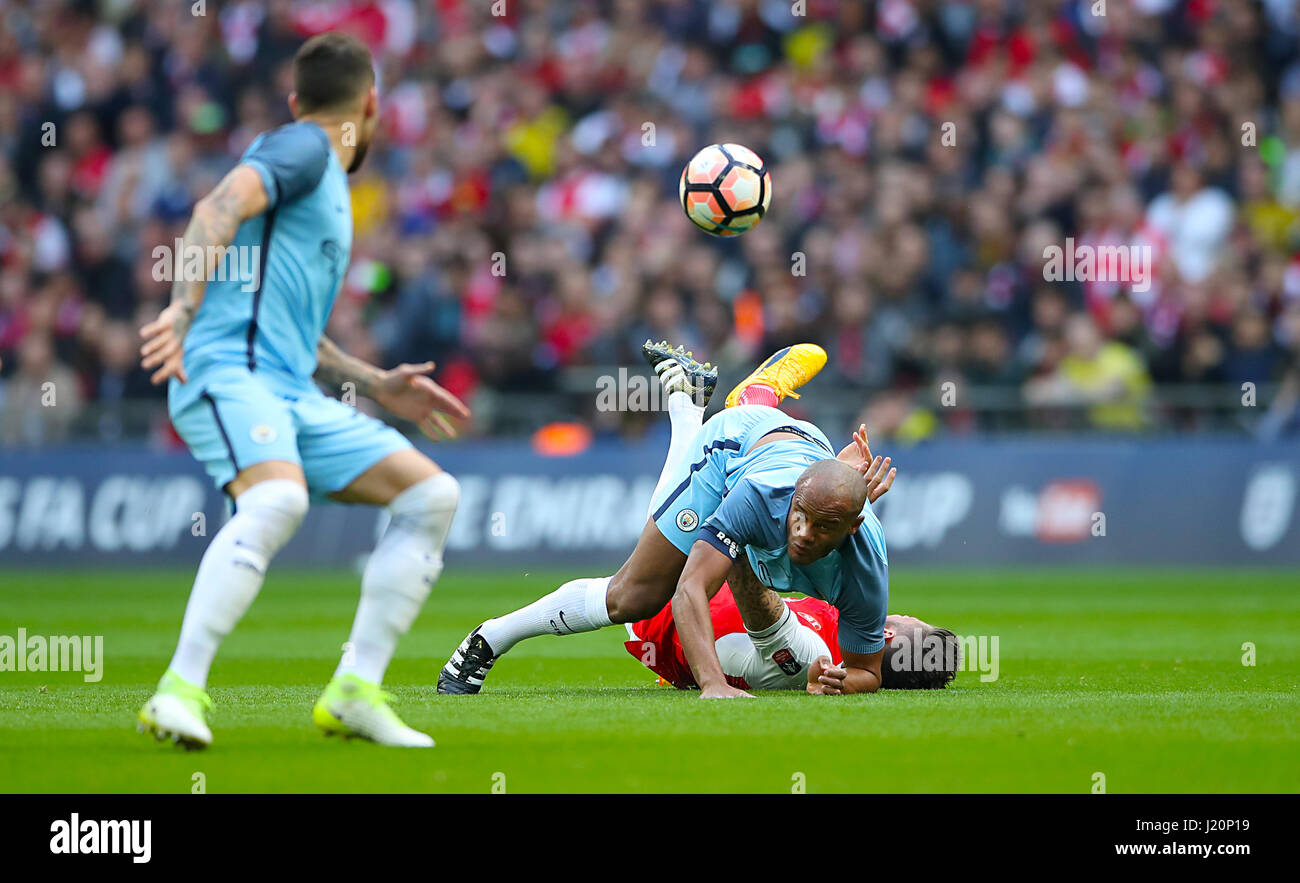 Manchester City's Vincent Kompany (centre) and Arsenal's Olivier Giroud ...