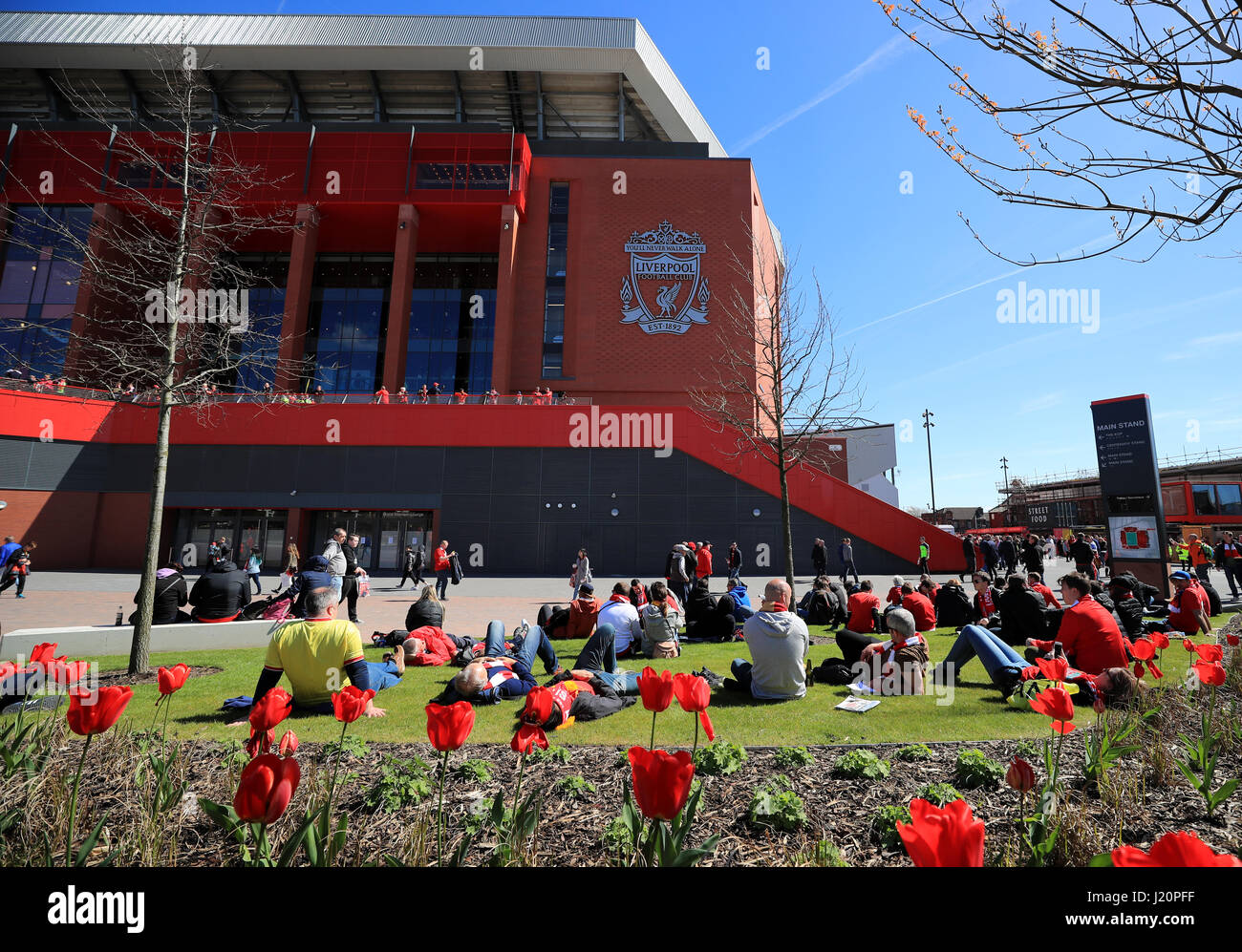 Fans enjoy the sunshine outside Anfield, Liverpool Stock Photo - Alamy