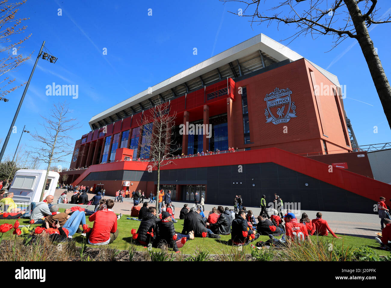 Fans enjoy the sunshine outside Anfield, Liverpool Stock Photo - Alamy