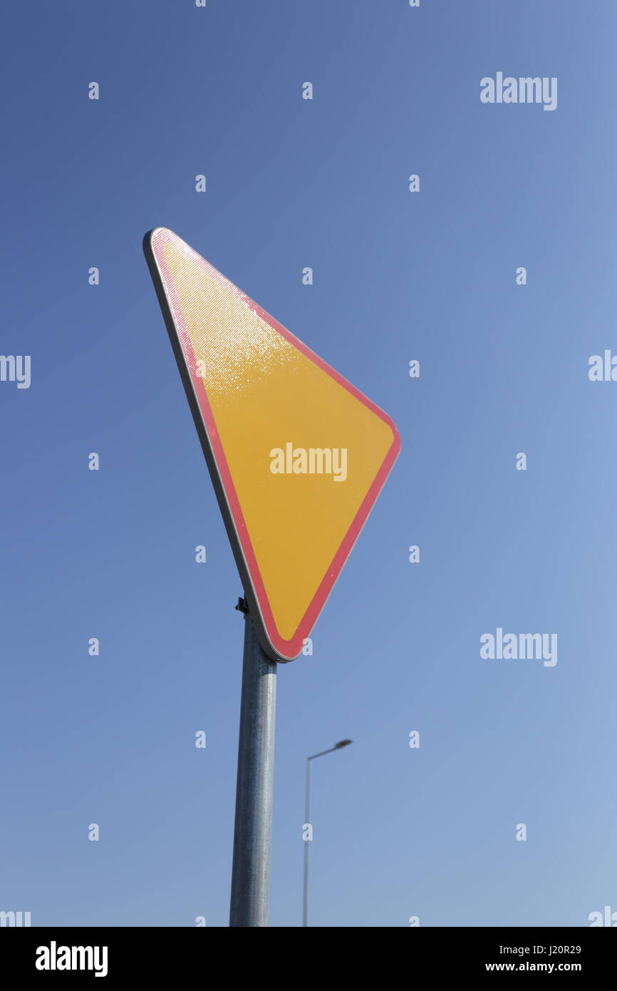 Give way yellow traffic sign Stock Photo - Alamy