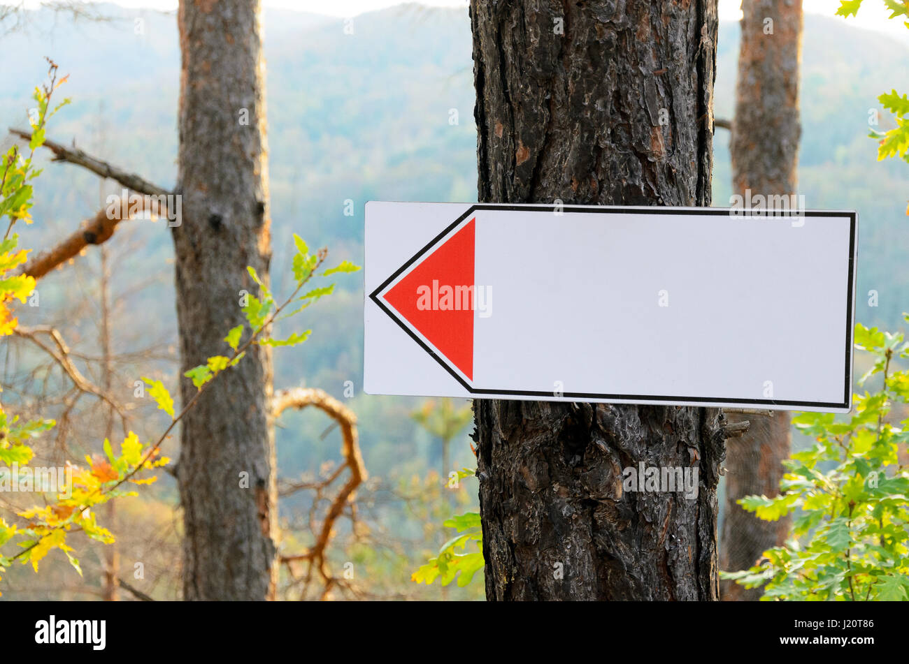 Blank white signboard in the forest with red arrow pointing left Stock ...