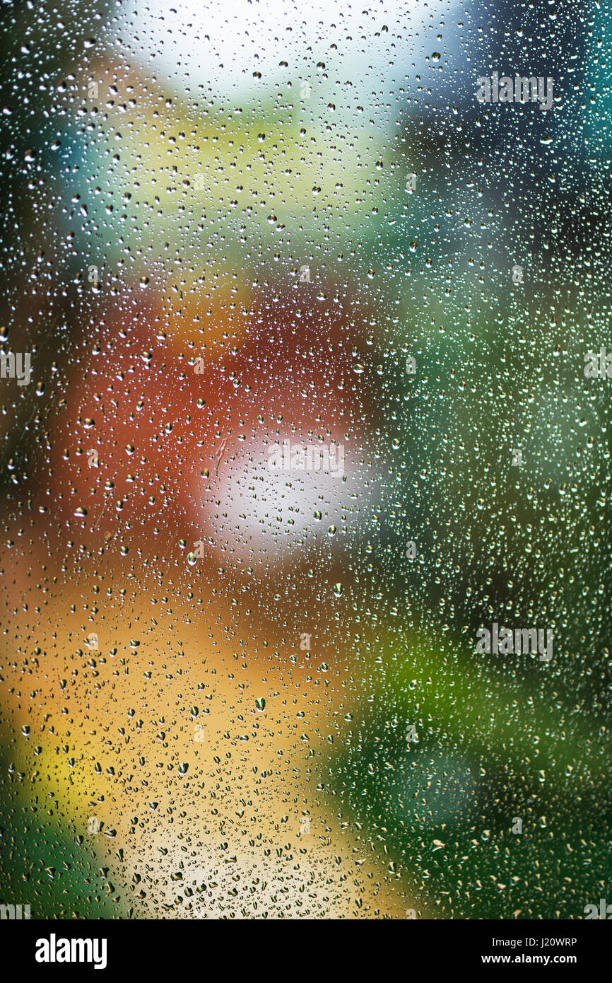 Drops of rain on window with abstract bokeh lights Stock Photo - Alamy