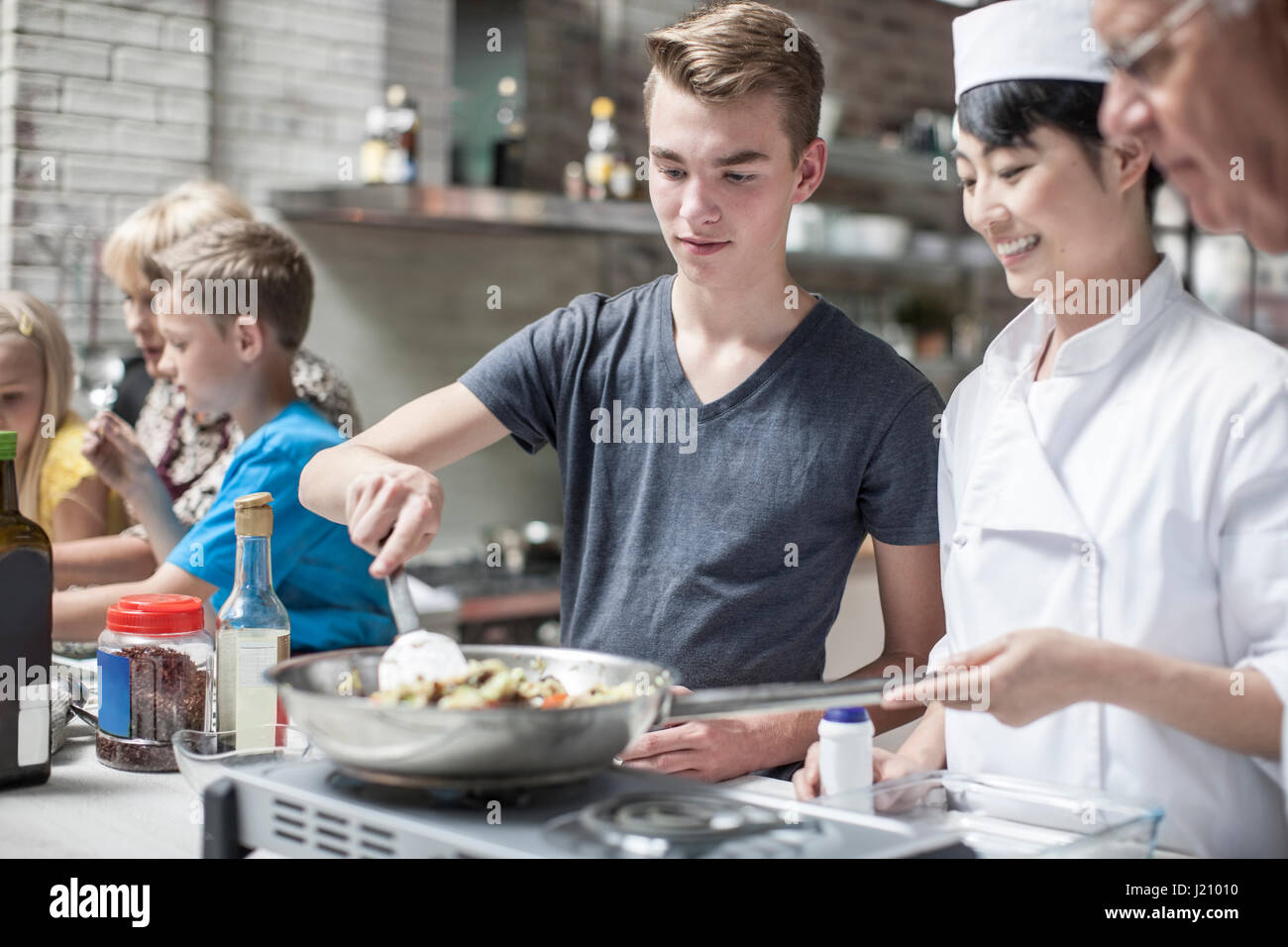 Teenager and female chef cooking together Stock Photo - Alamy