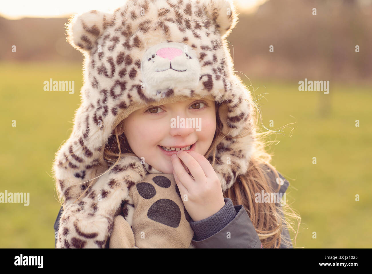 Portrait of shy little girl wearing hat with leopard print Stock Photo ...