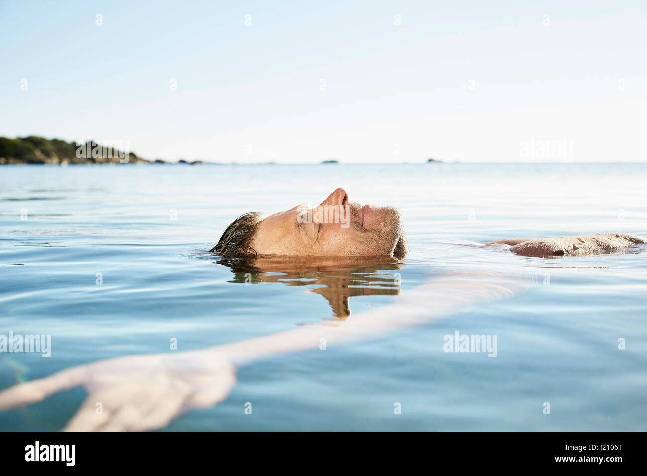 Relaxed mature man floating in the sea Stock Photo - Alamy