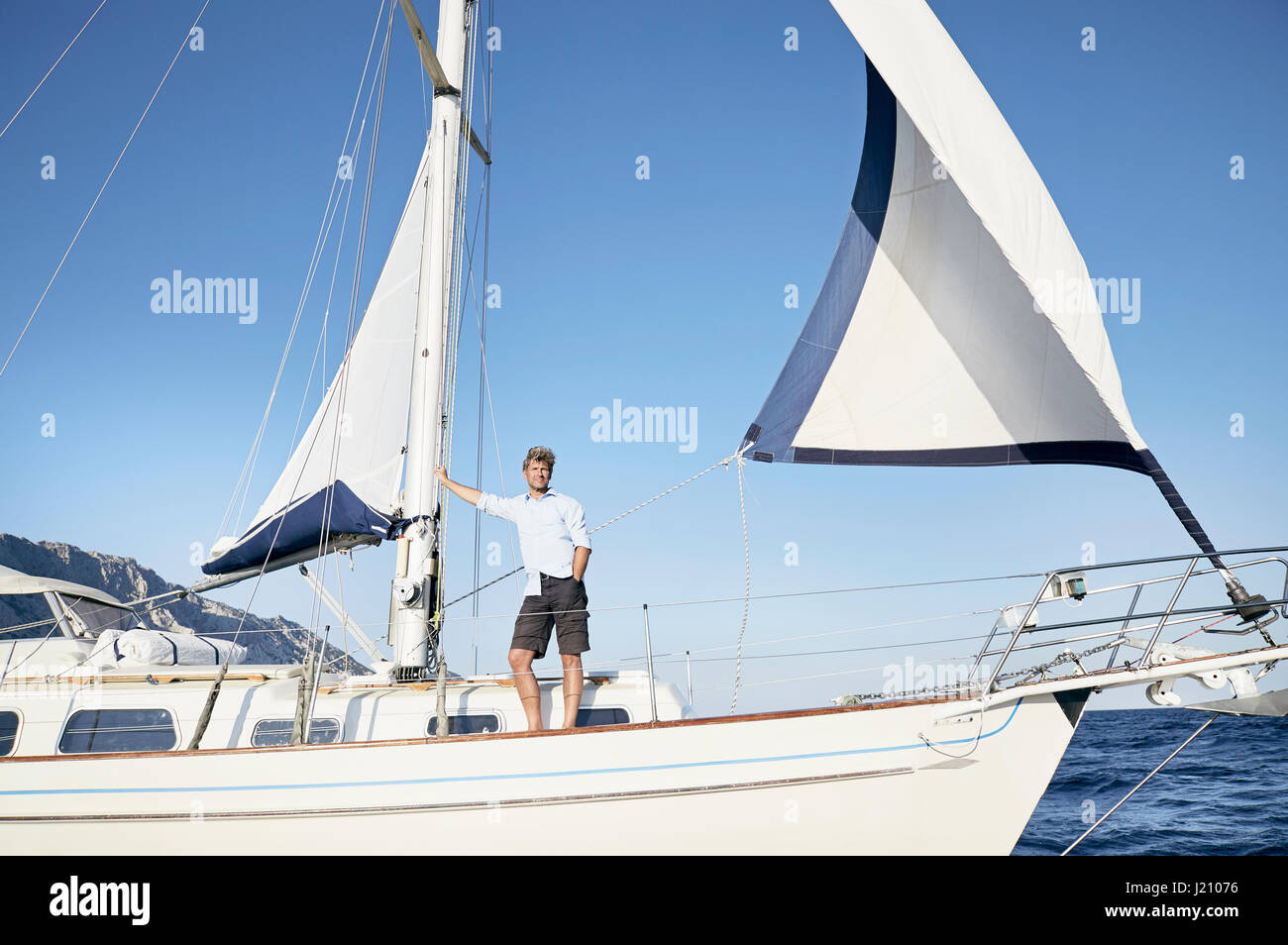 Mature man standing on his sailing boat Stock Photo - Alamy